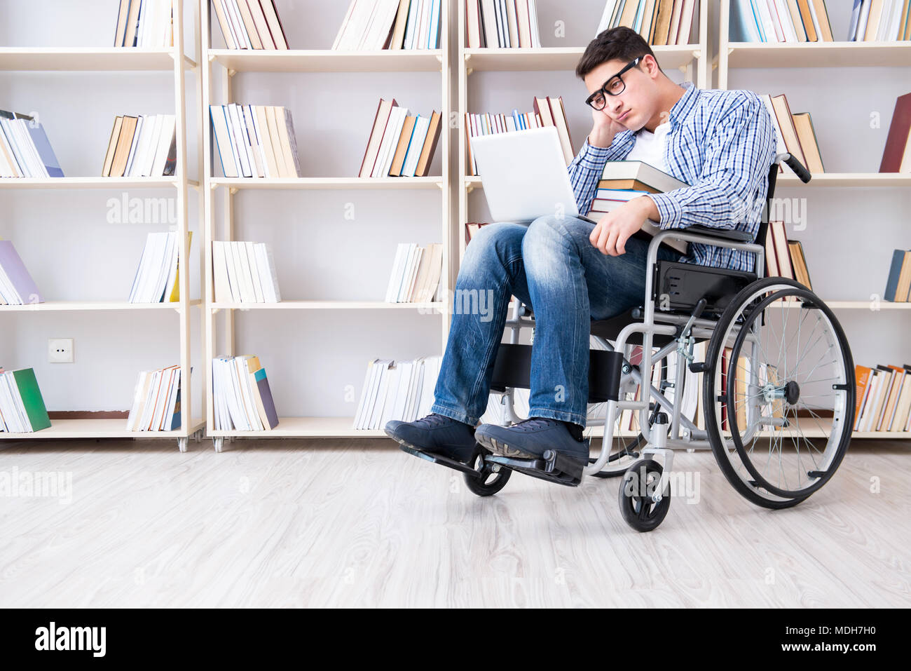 Disabled student studying in the library Stock Photo - Alamy