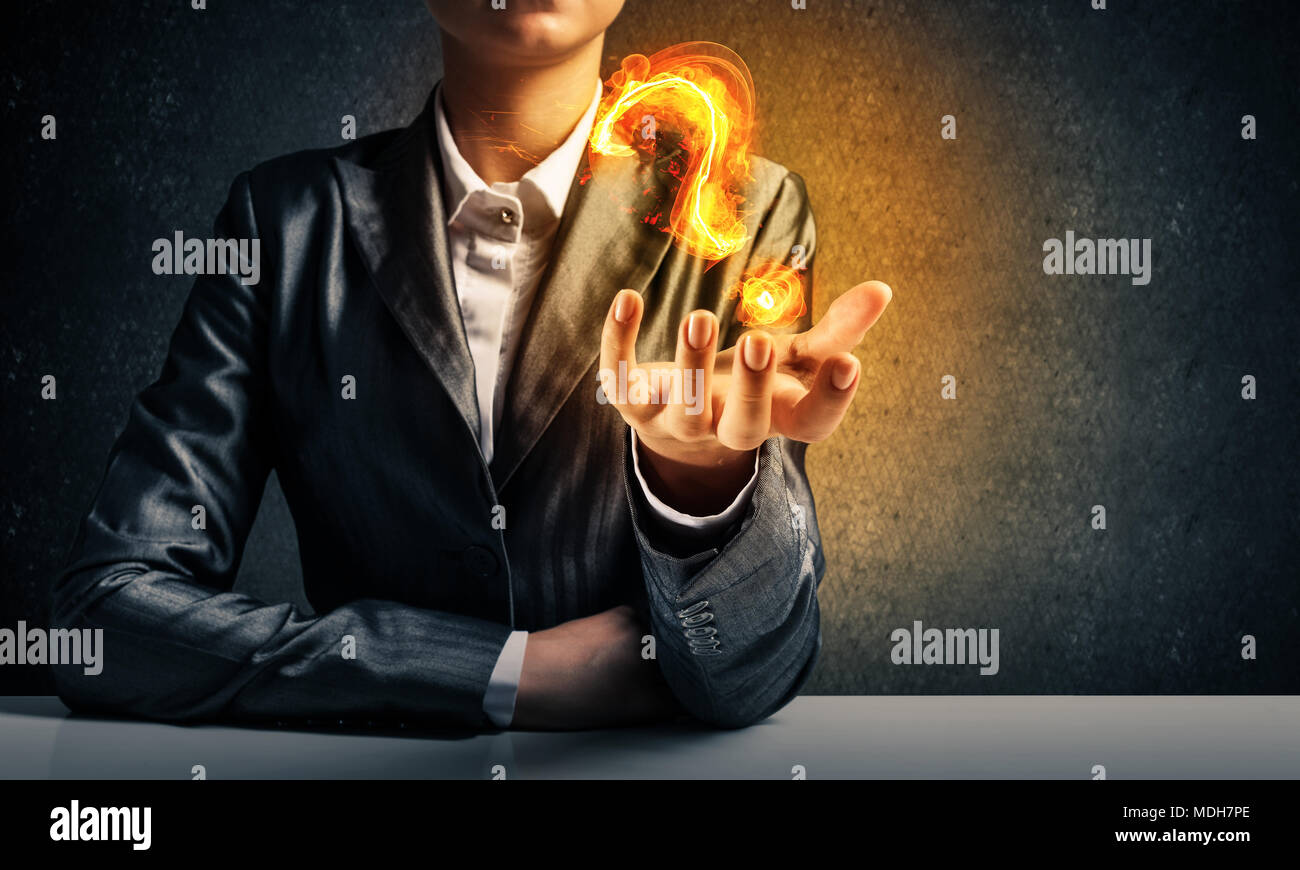 Businessman presenting question mark Stock Photo - Alamy