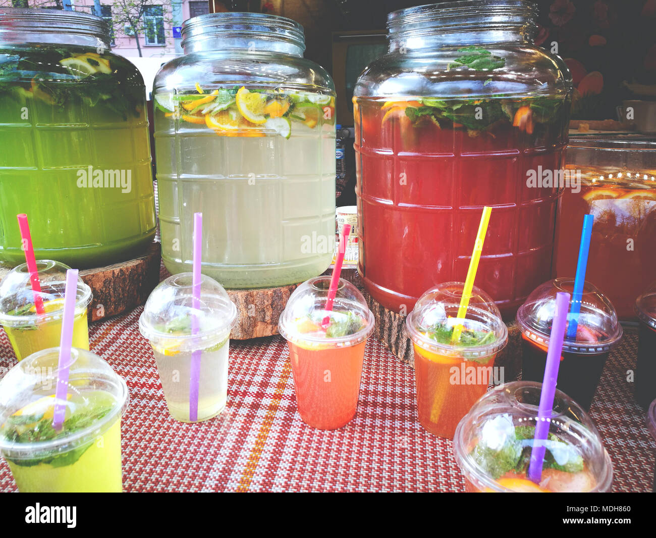 lemonade with mint and lemons space in plastic glass with straws street ...