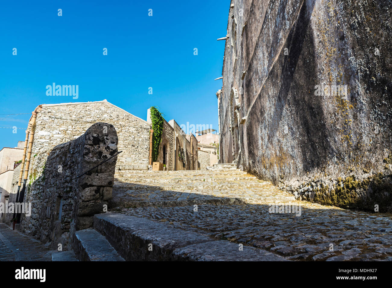 Street of the old town with steps of the historic village of Erice in ...