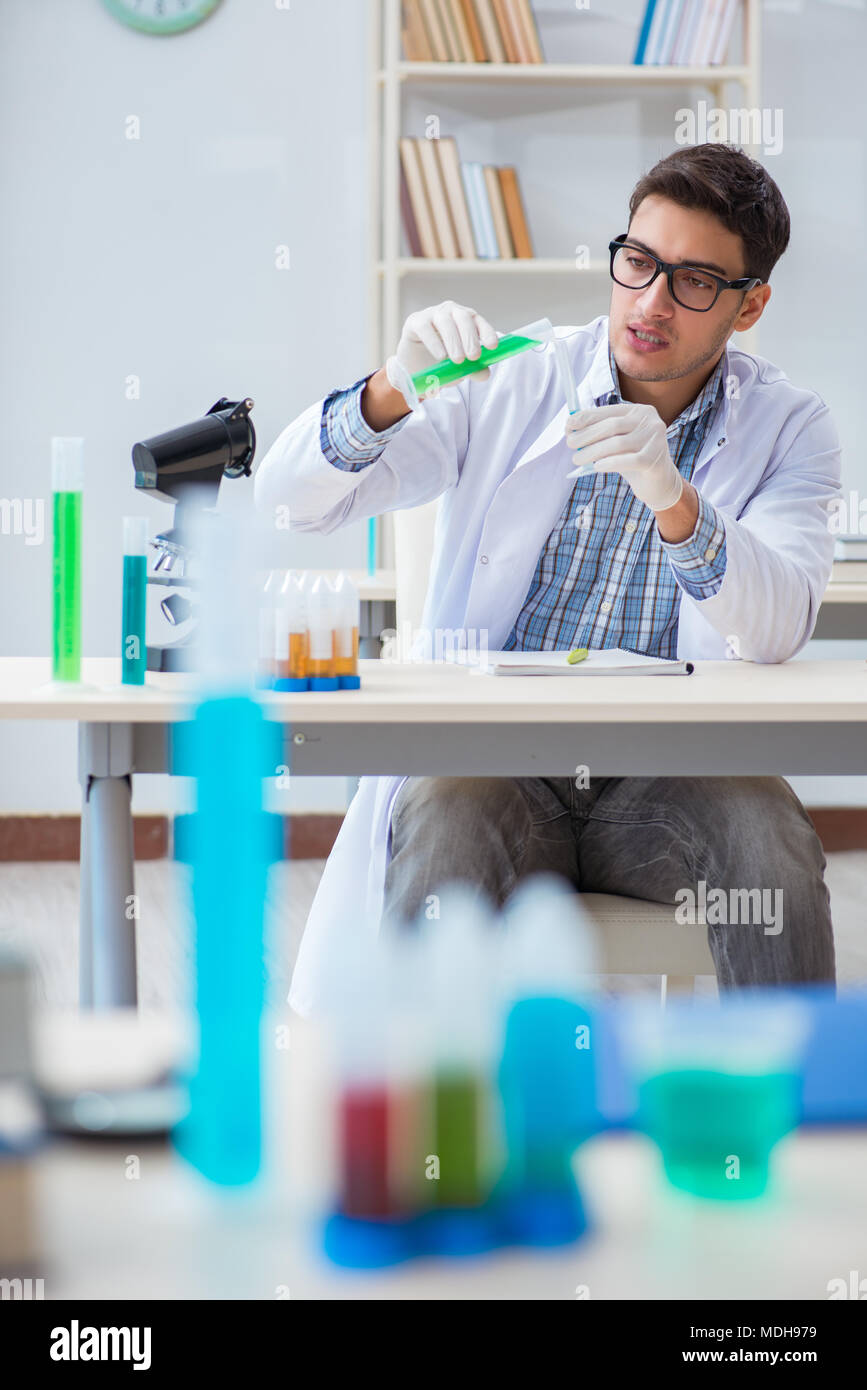 Young chemist student working in lab on chemicals Stock Photo - Alamy