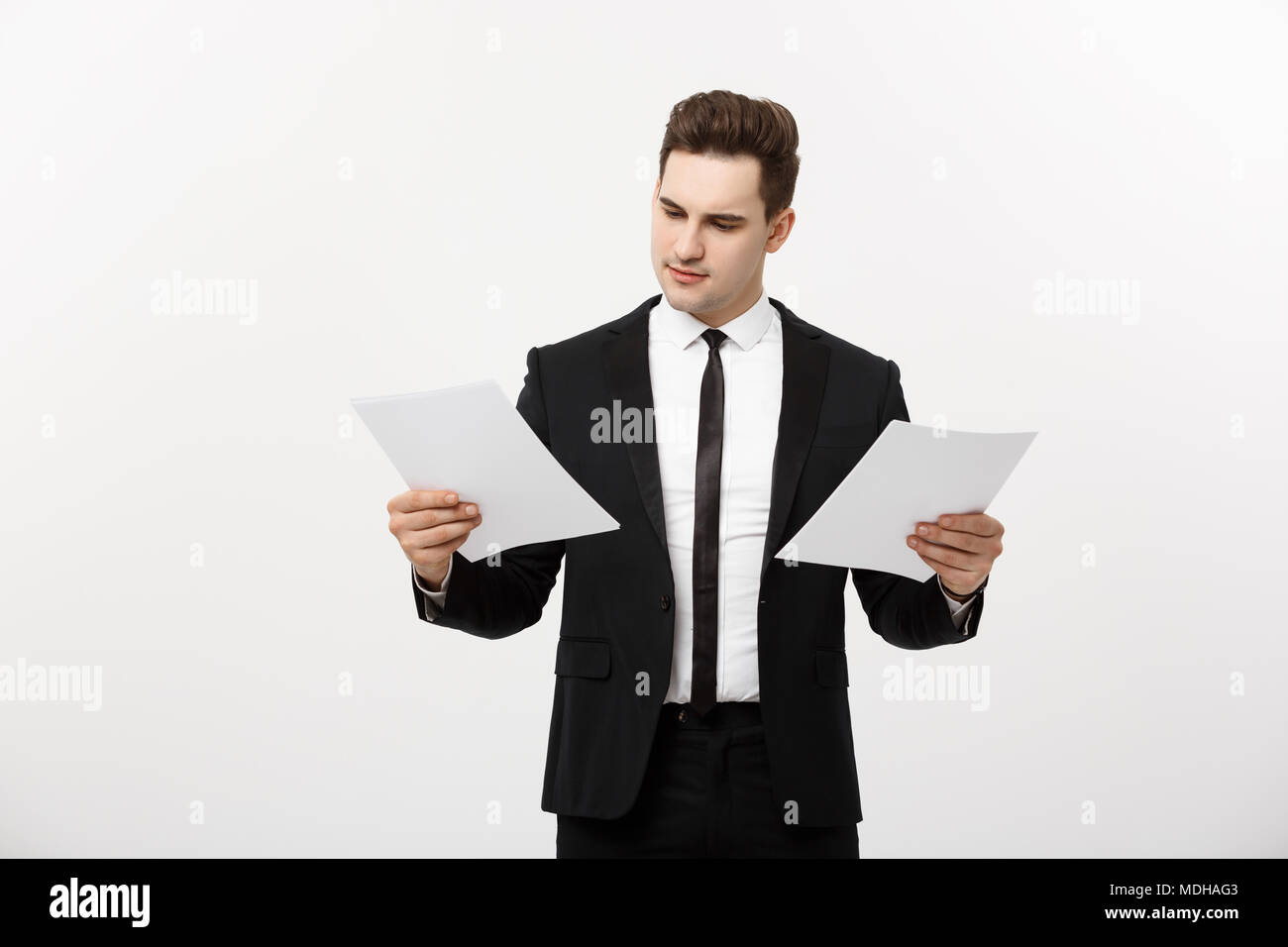 Business Concept: Attentive handsome businessman working comparing ...