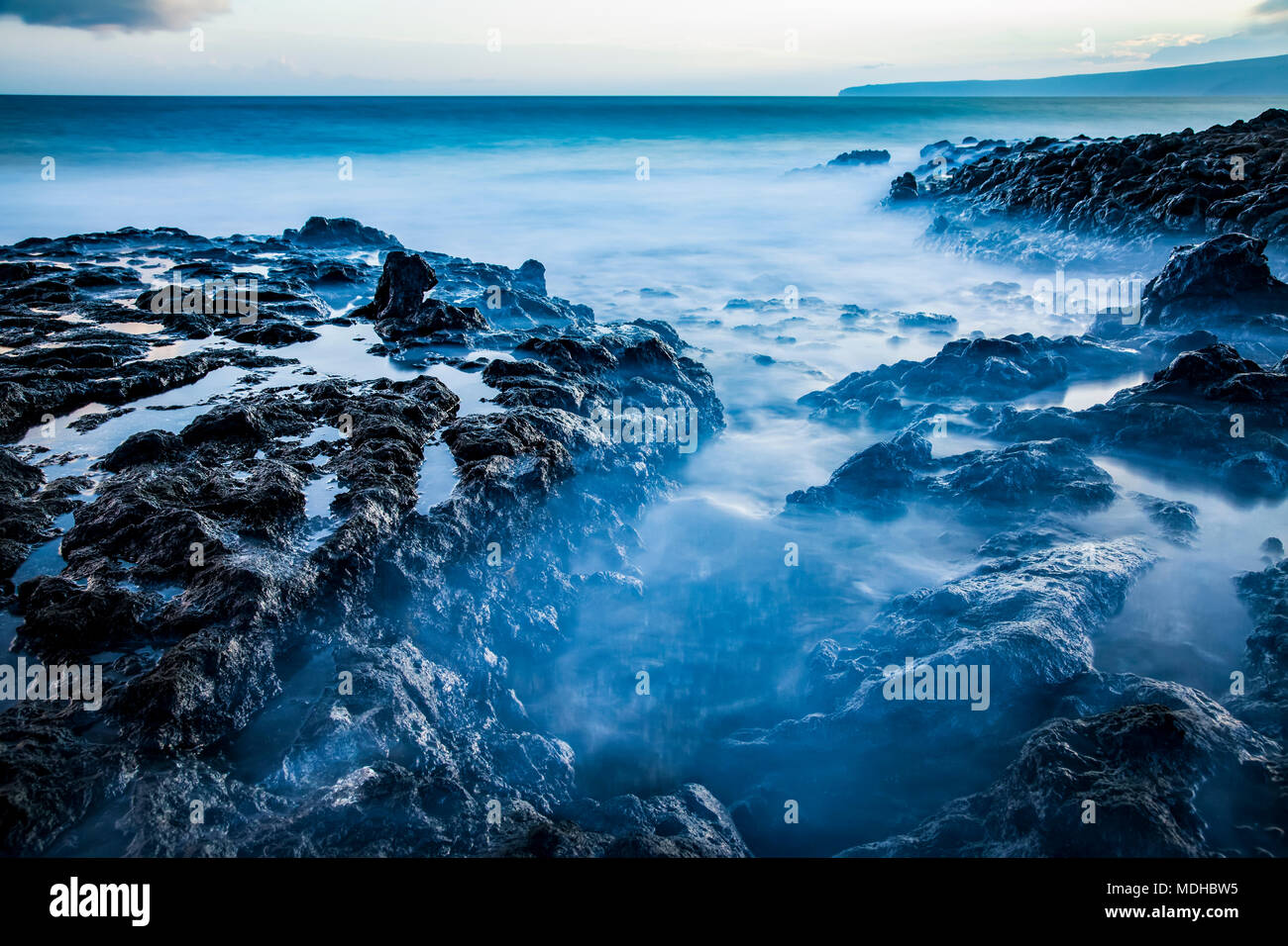 Long exposure of tide pools along the coastline and a view of the ...