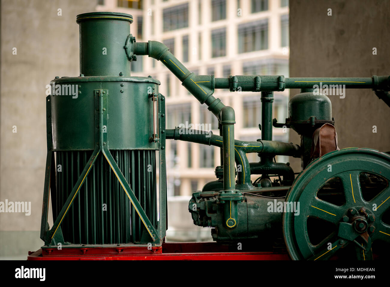 Old fashioned tractor engine painted green up close Stock Photo - Alamy