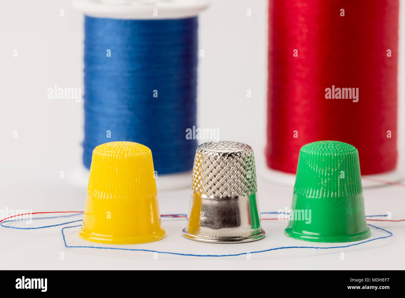 Tools used for sewing with thread and thimbles Stock Photo - Alamy