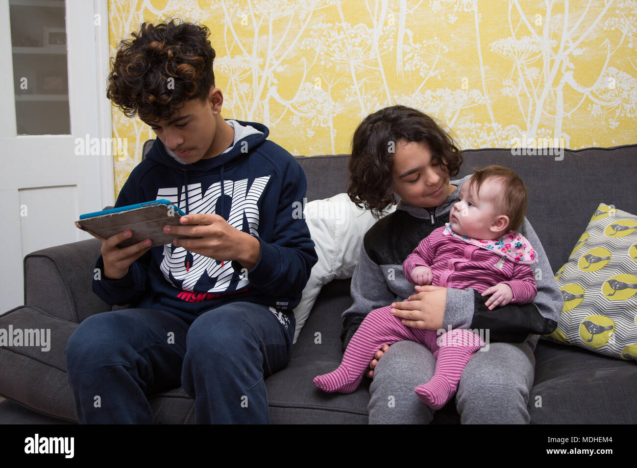 Teenager babysitting sister hi-res stock photography and images - Alamy