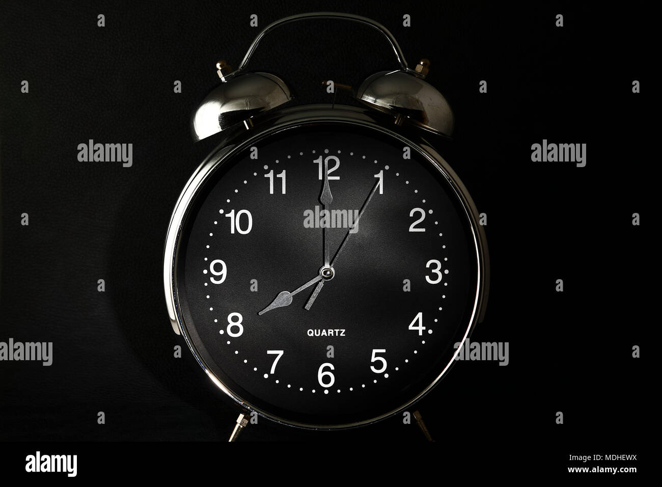 Old retro alarm clock with the hands set to 7:00 am or pm Stock Photo ...