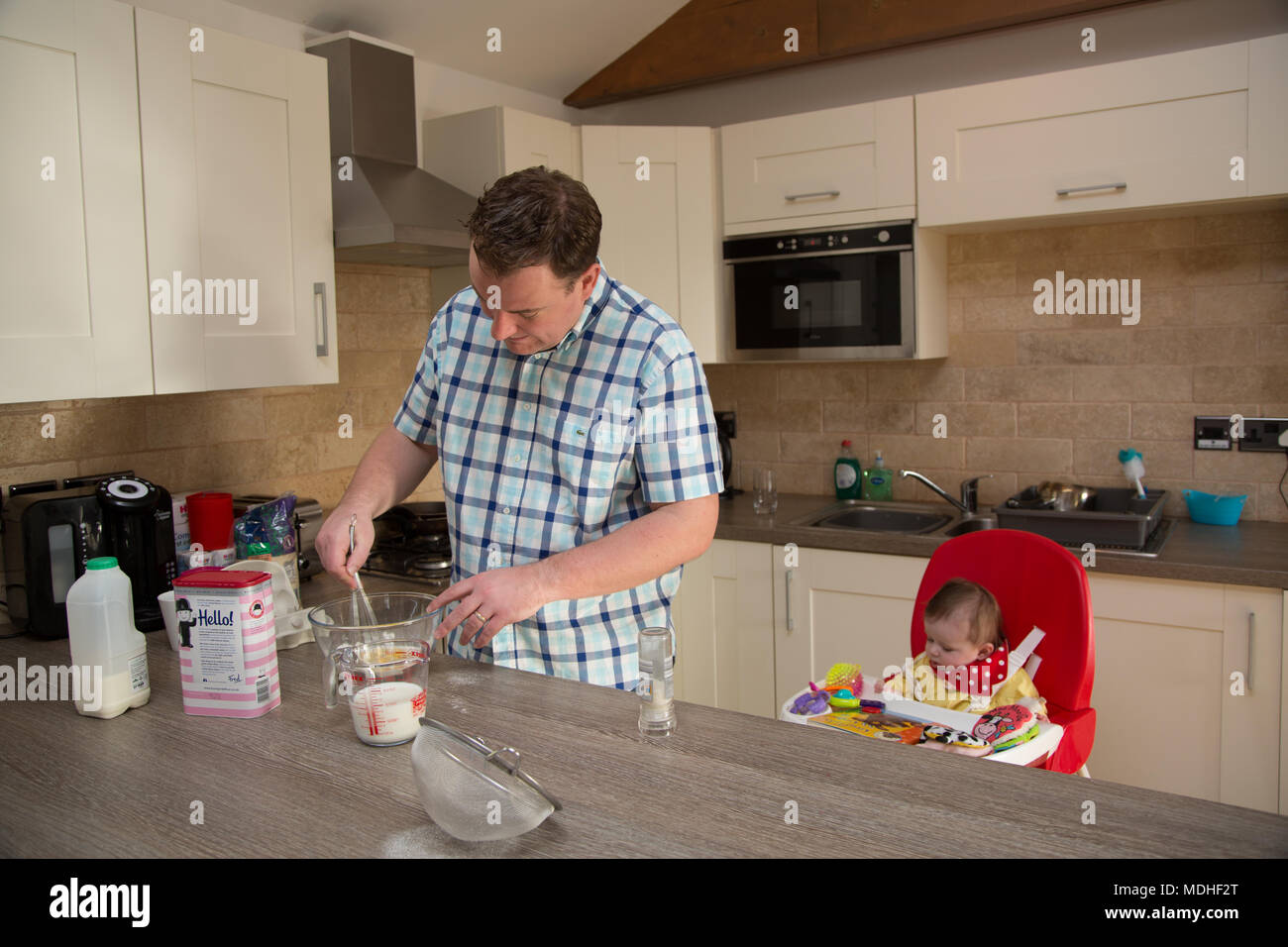 Dad cooking with baby Stock Photo - Alamy