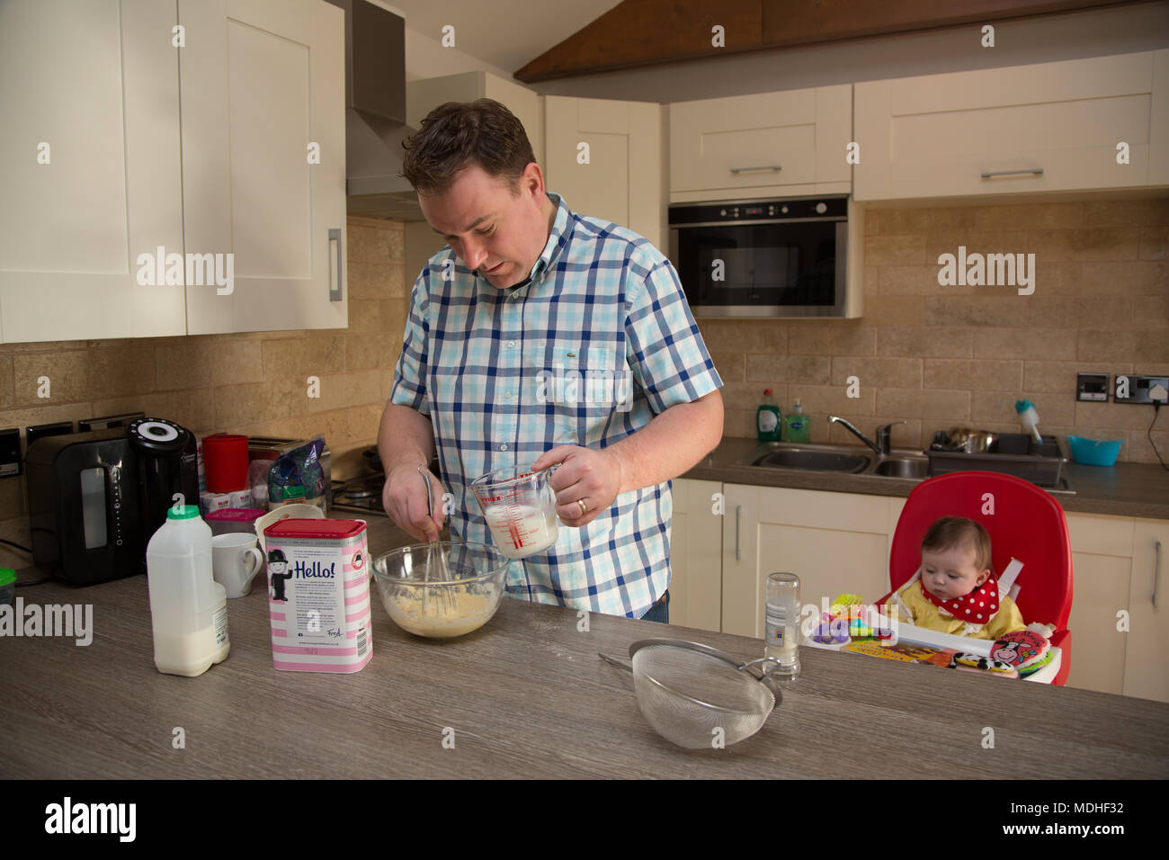 Dad cooking with baby Stock Photo - Alamy