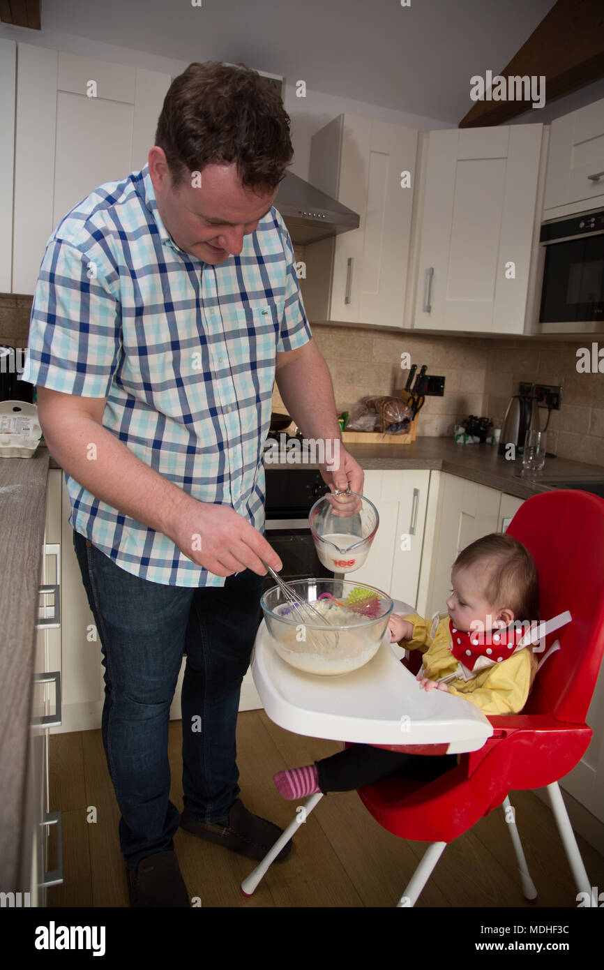 Dad cooking with baby Stock Photo - Alamy