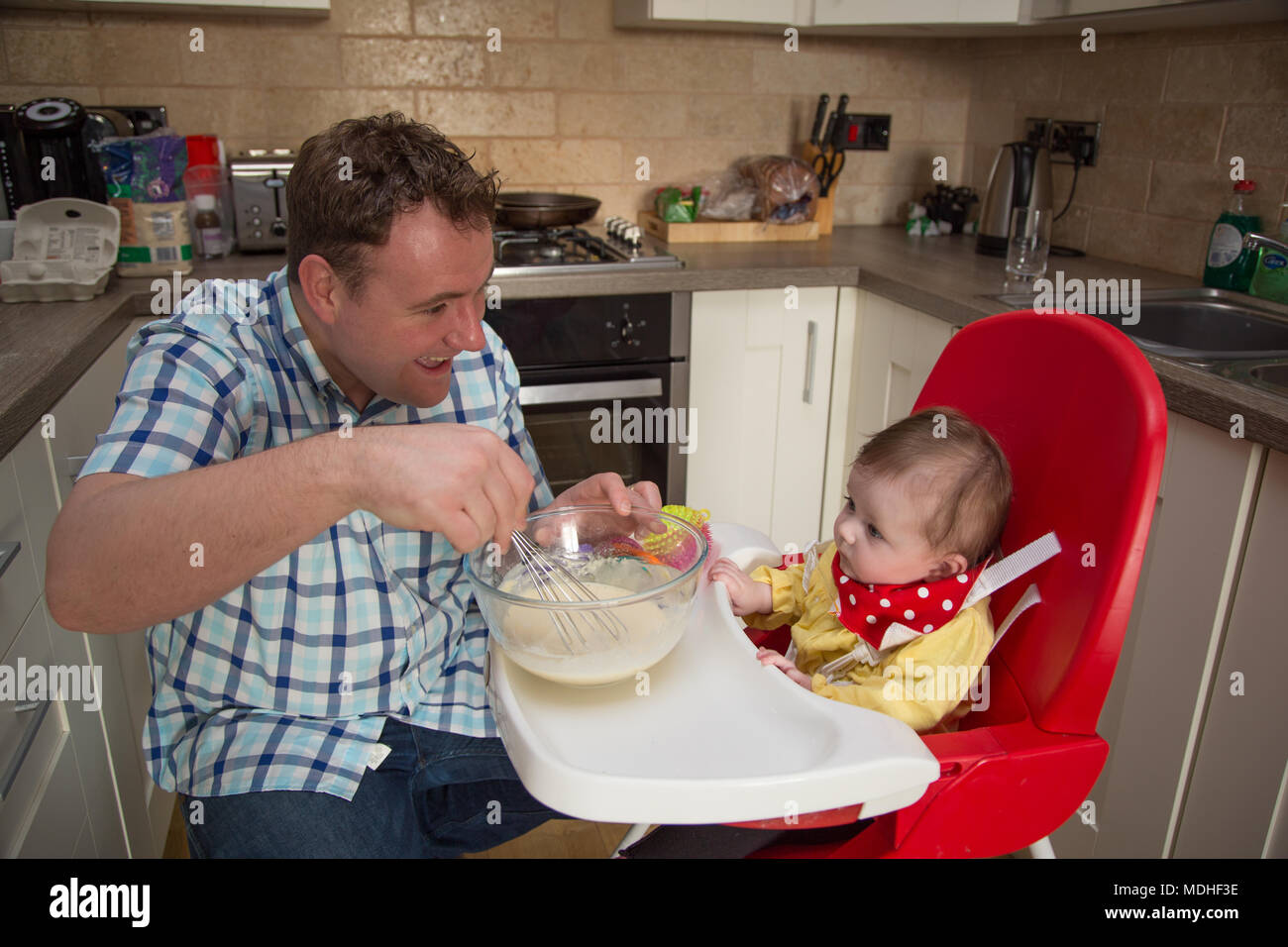 Dad cooking with baby Stock Photo - Alamy