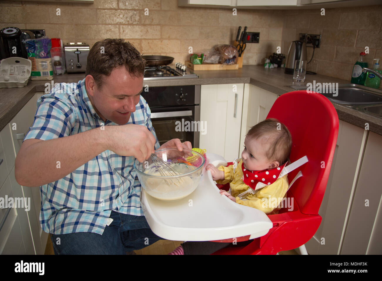Dad cooking with baby Stock Photo - Alamy