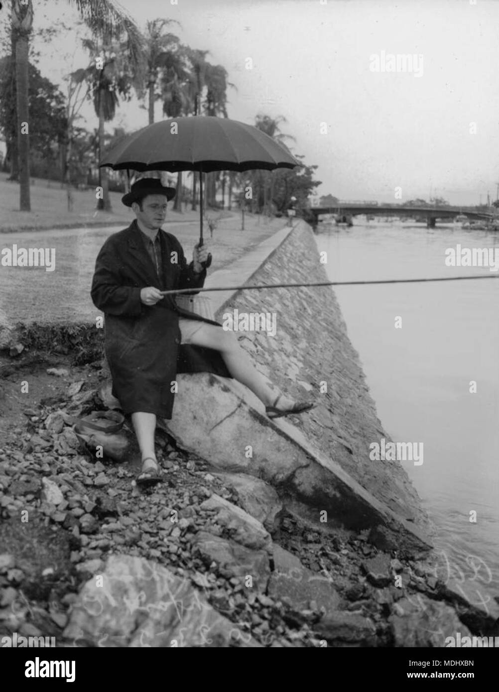 Adrian Zana fishing in the rain at Breakfast Creek, 1952 Stock Photo ...