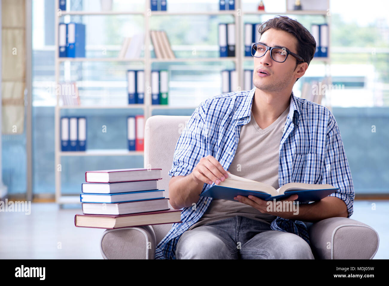 Student reading books and preparing for exams in library Stock Photo ...