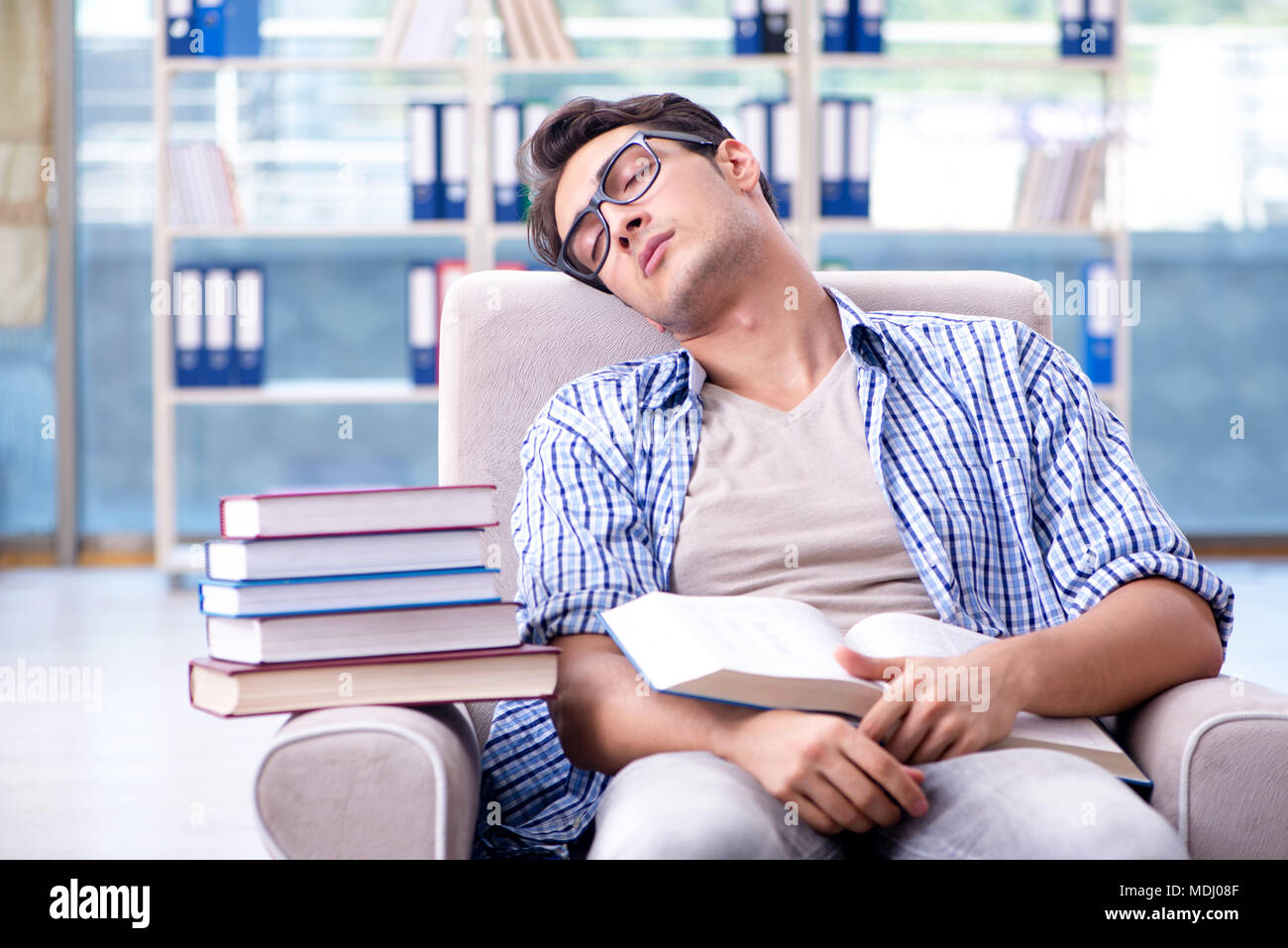 Student reading books and preparing for exams in library Stock Photo ...