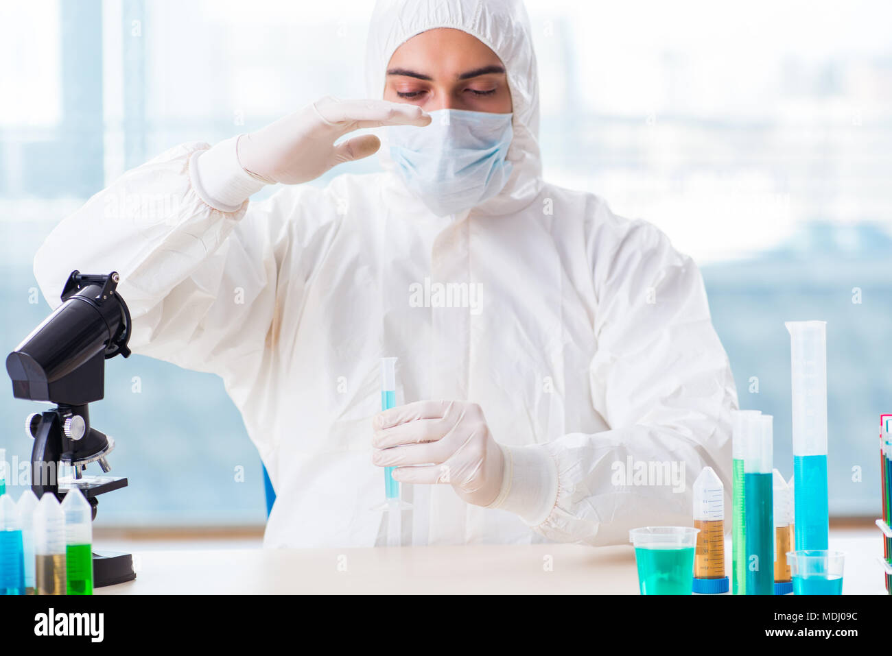 Young chemist student working in lab on chemicals Stock Photo - Alamy