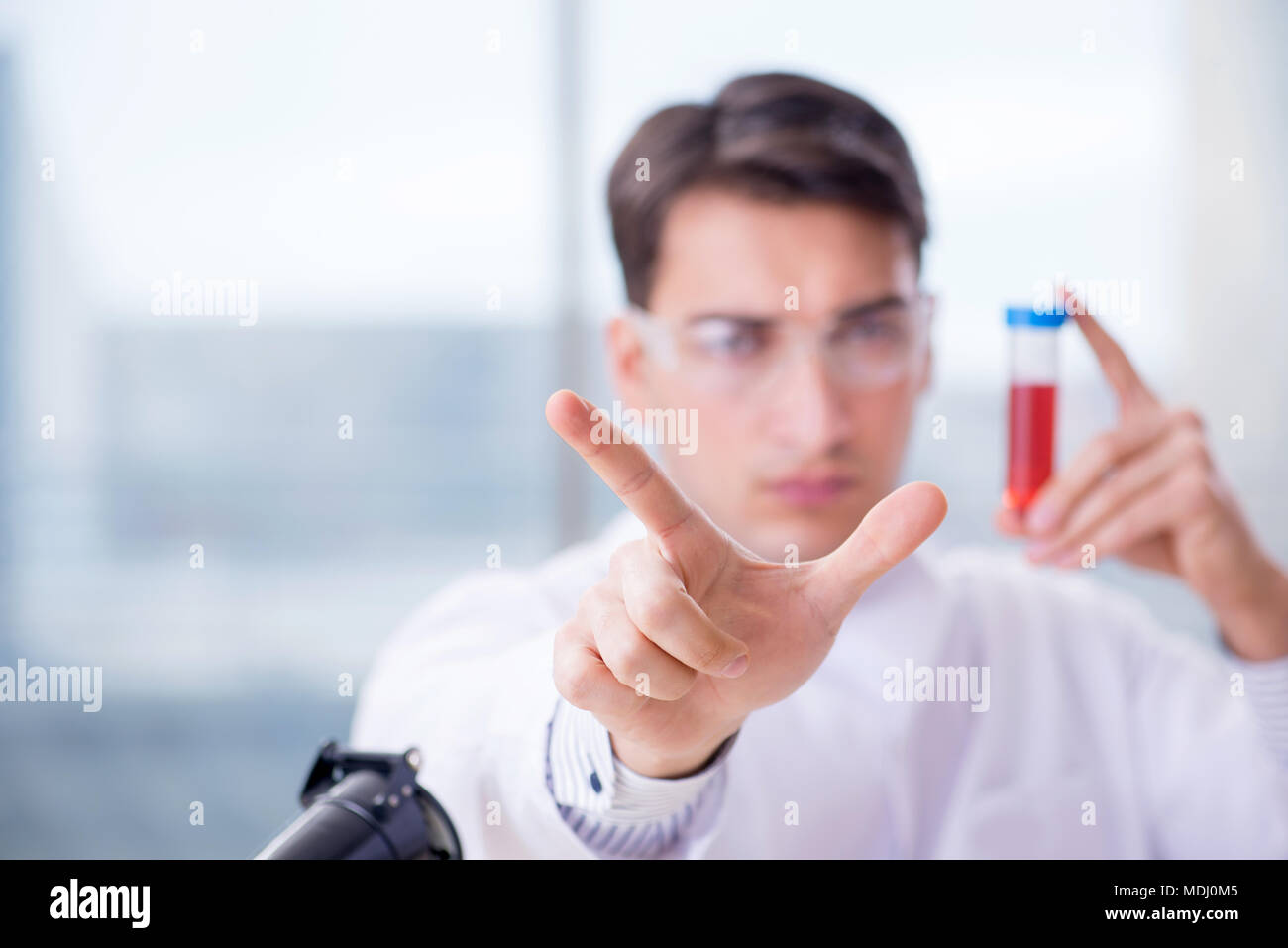 Man doctor checking blood samples in lab Stock Photo - Alamy