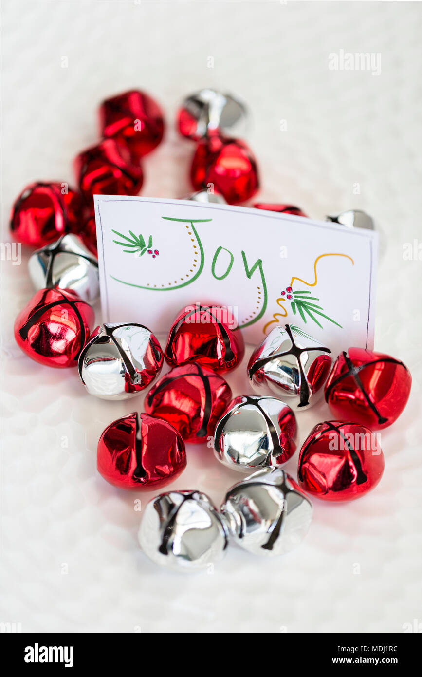 Red and silver bells with a sign saying joy for a Christmas decoration ...