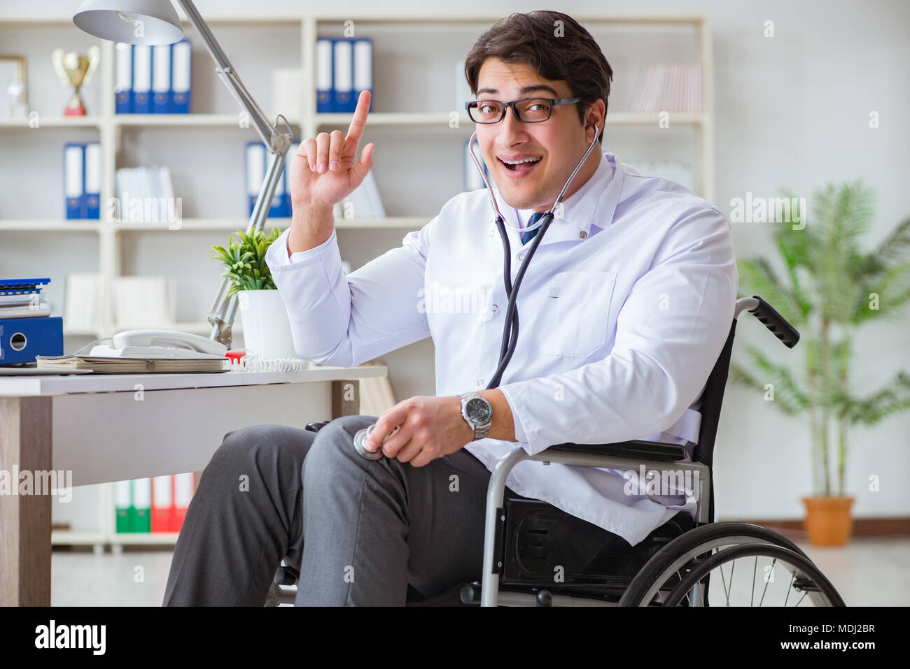 Disabled doctor on wheelchair working in hospital Stock Photo - Alamy
