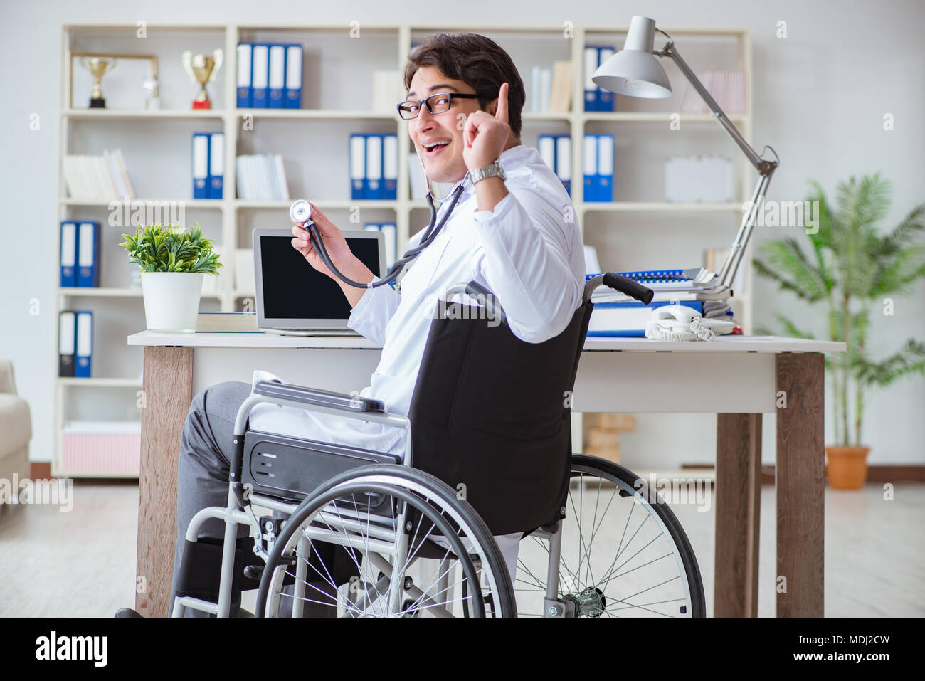 Disabled doctor on wheelchair working in hospital Stock Photo - Alamy