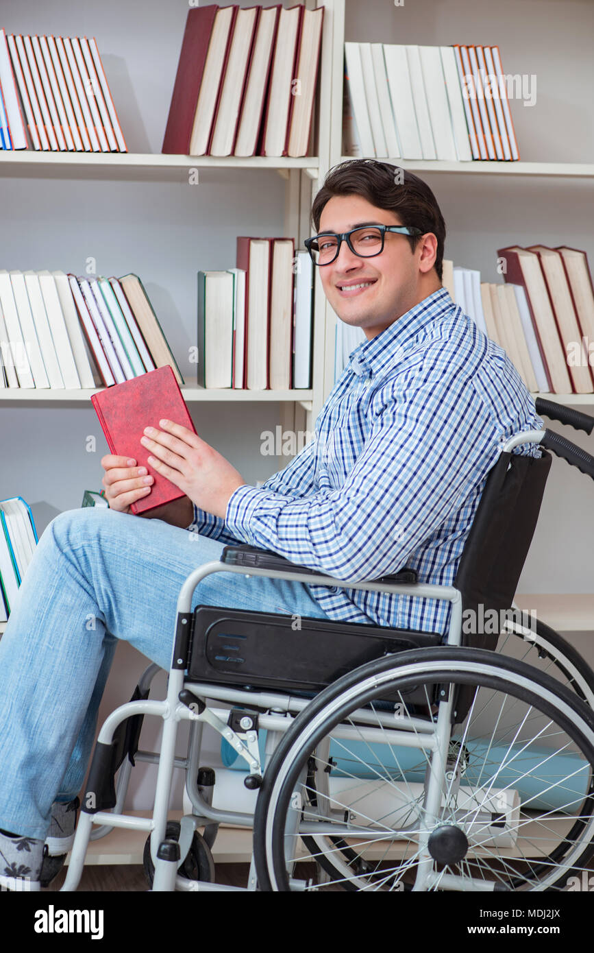Disabled student studying in the library Stock Photo - Alamy