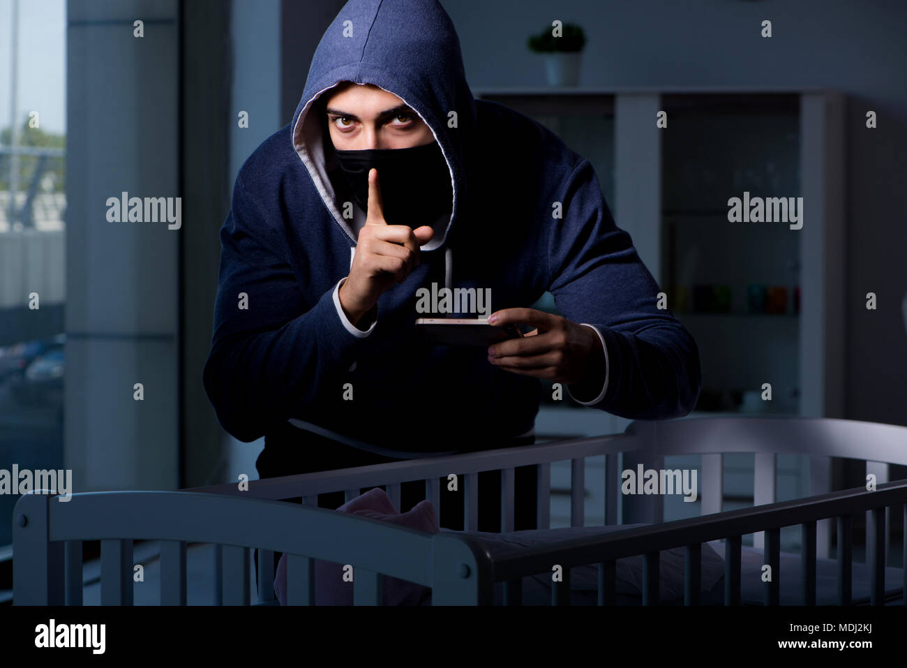 Criminal stealing baby in human child traficking concept Stock Photo ...