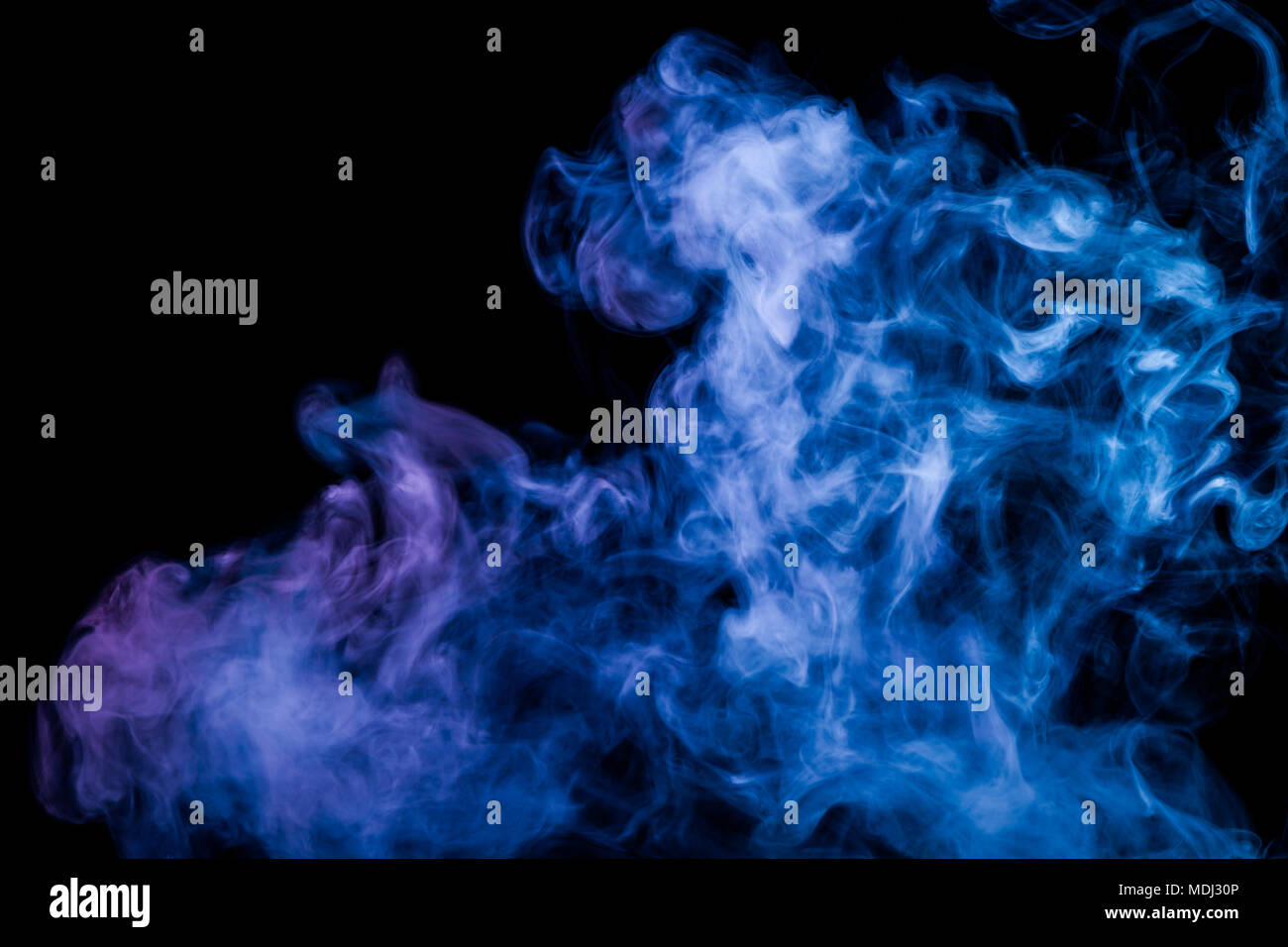 Thick colorful blue smoke on a black isolated background. Background ...