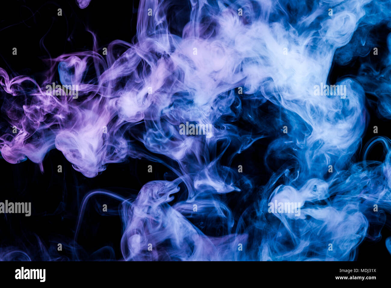 Thick colorful blue smoke on a black isolated background. Background ...