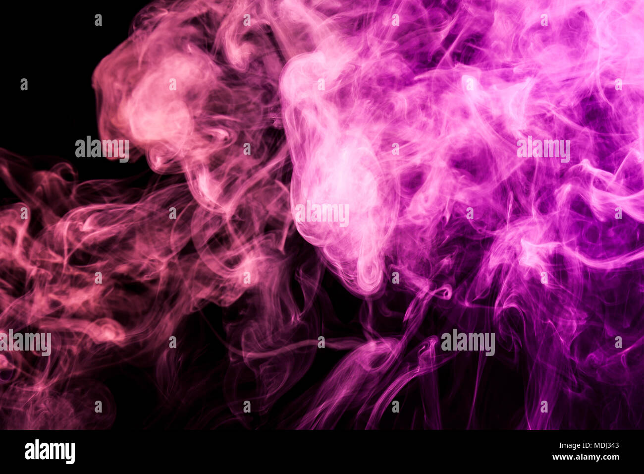 Colorful pink and red smoke on a black isolated background. Background ...