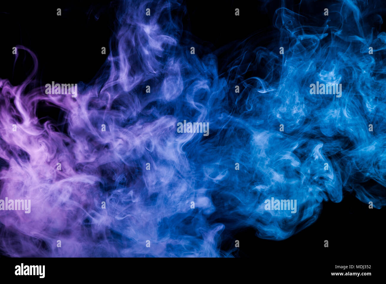 Thick colorful blue smoke on a black isolated background. Background ...