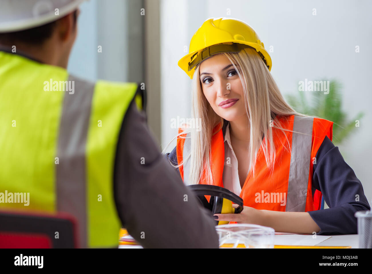 Construction workers having discussion in office before starting ...