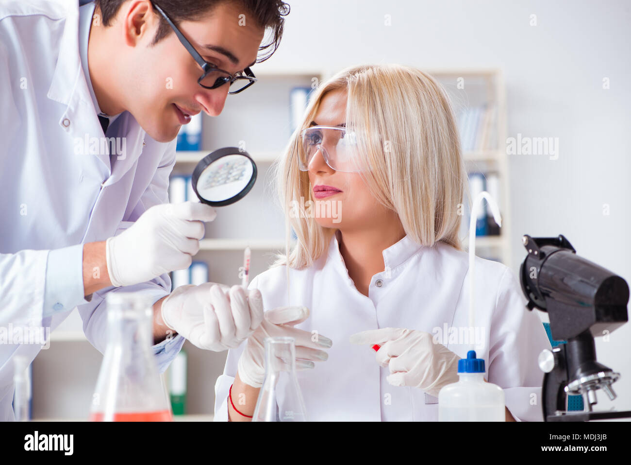 Two chemists having discussion in lab Stock Photo - Alamy