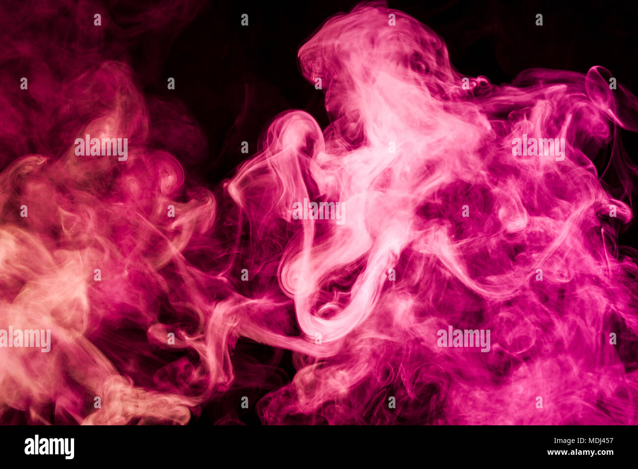 Pink and red cloud of smoke of black isolated background. Background ...