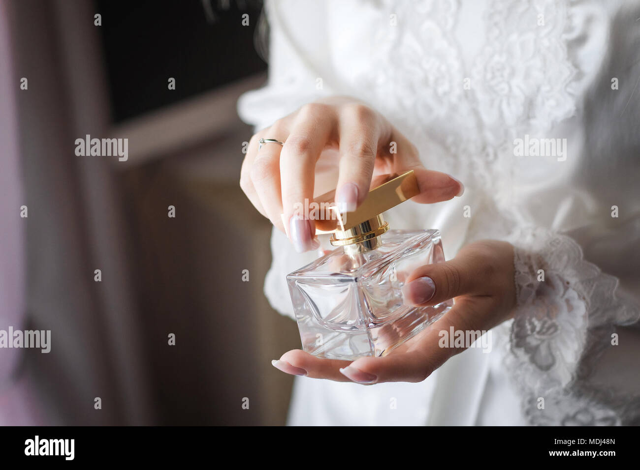 bride opening a flacon of a fragrant perfume Stock Photo - Alamy