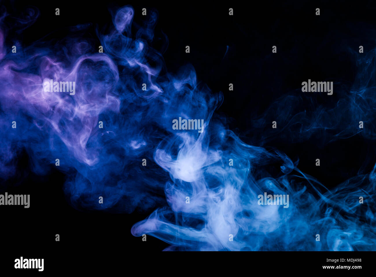 Colorful blue smoke on a black isolated background. Background from the ...
