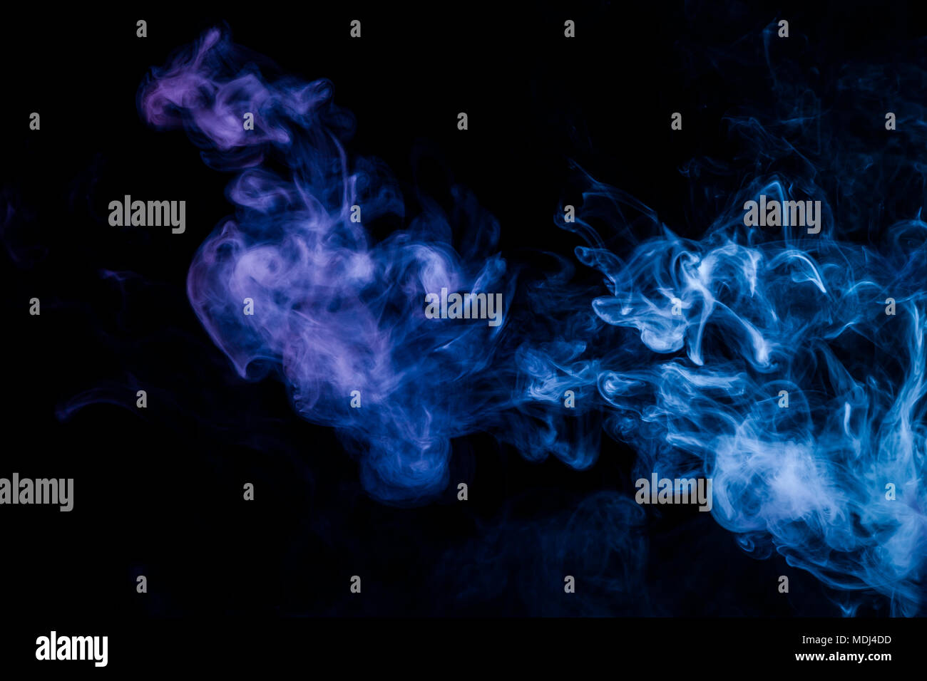 Colorful blue smoke on a black isolated background. Background from the ...