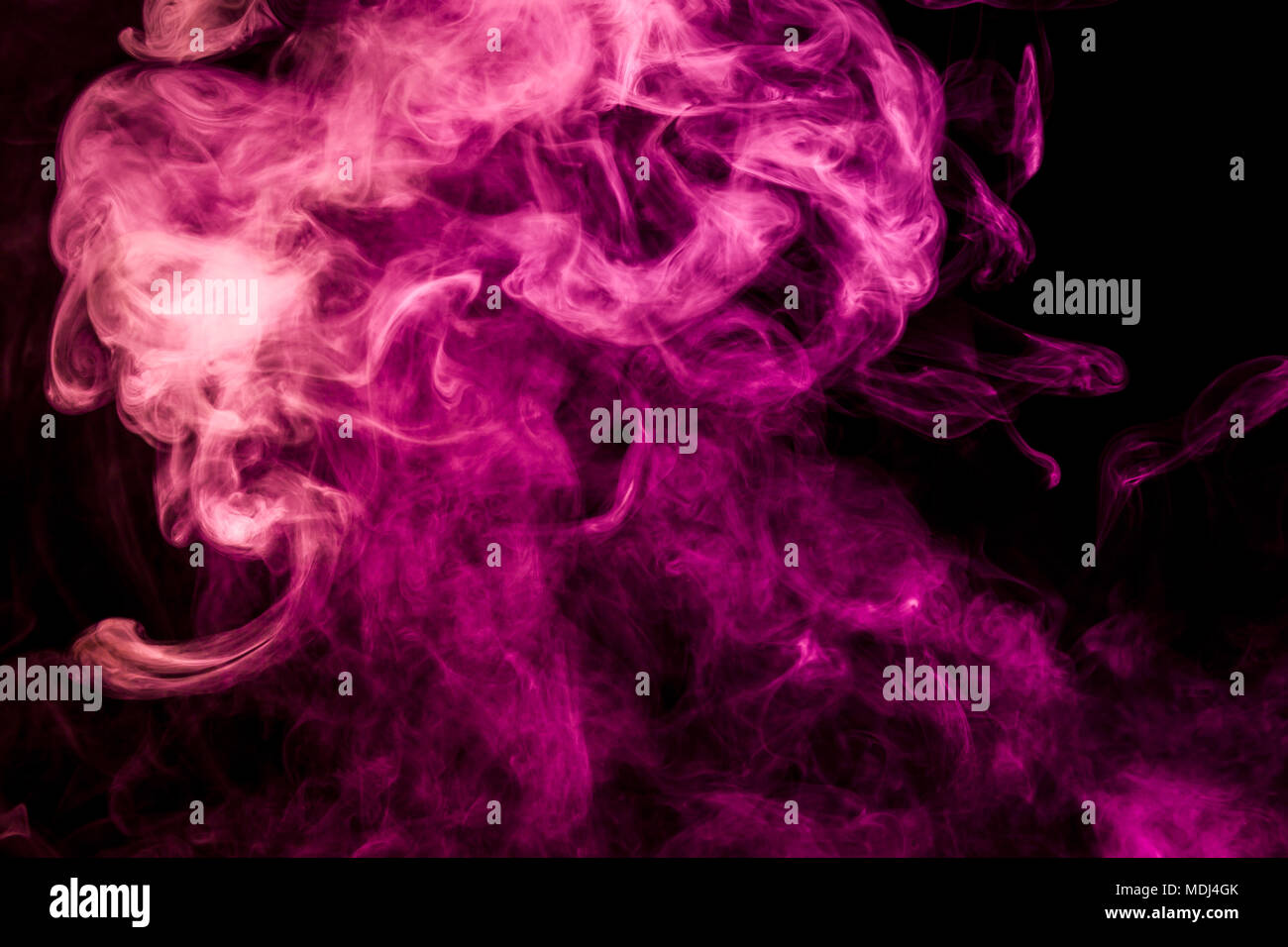 Dense multicolored pink and red smoke on a black isolated background ...