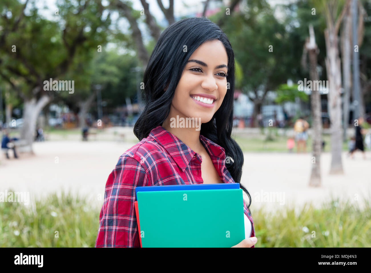 Beautiful native latin american female student outdoors on campus of ...