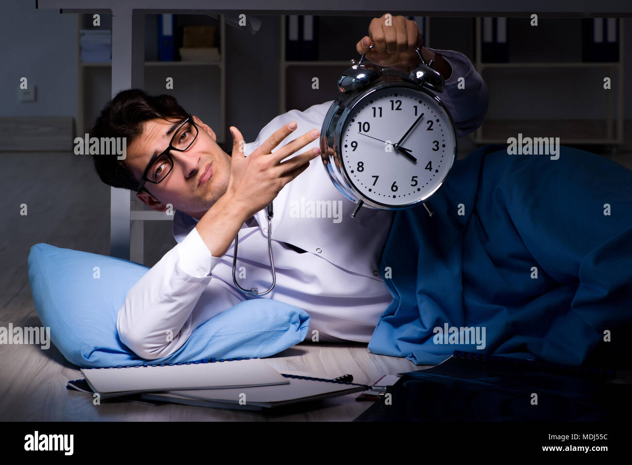 Doctor working night shift in hospital after long hours Stock Photo - Alamy