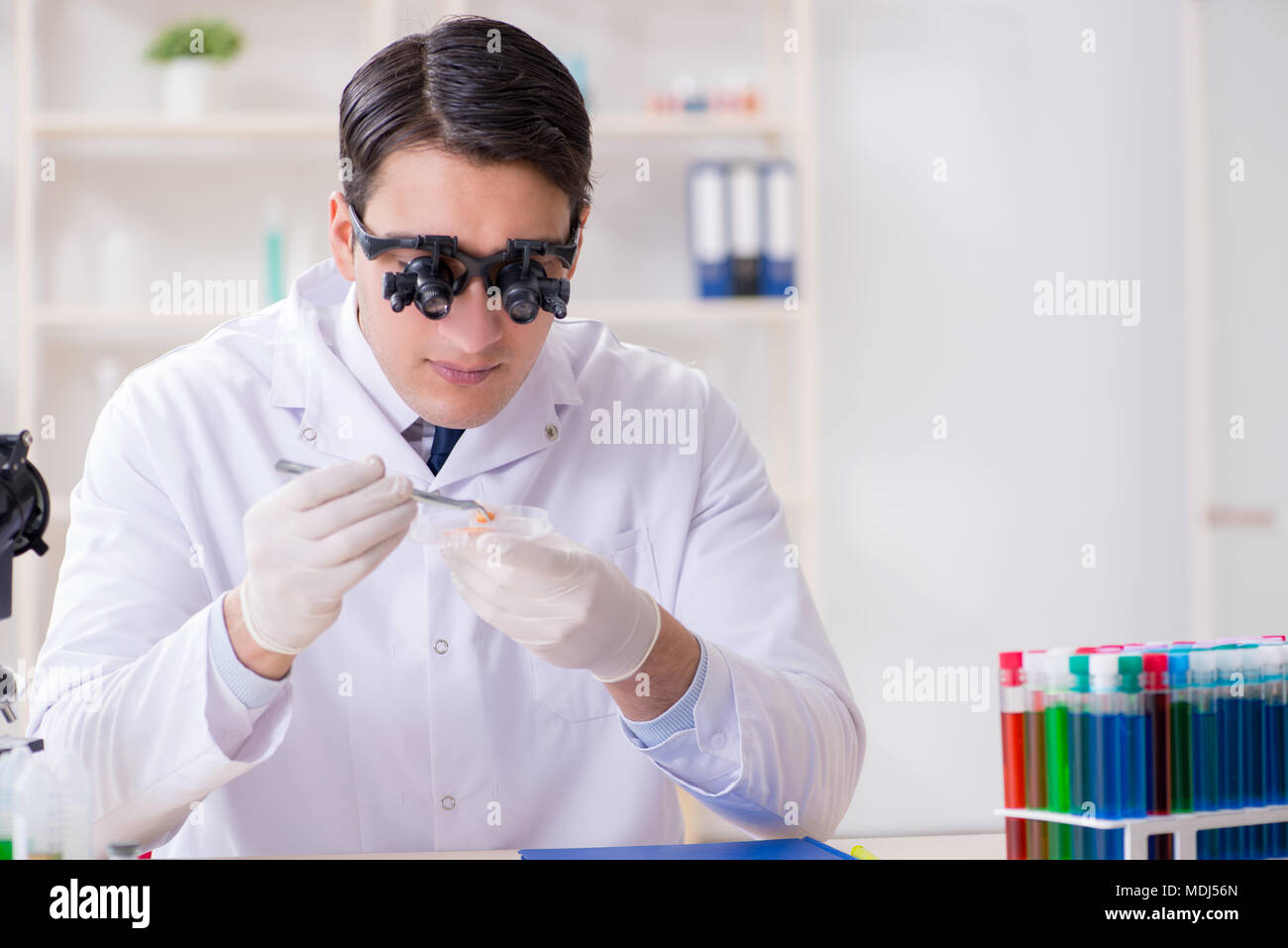 Drug synthesis concept with chemist working in research lab Stock Photo ...