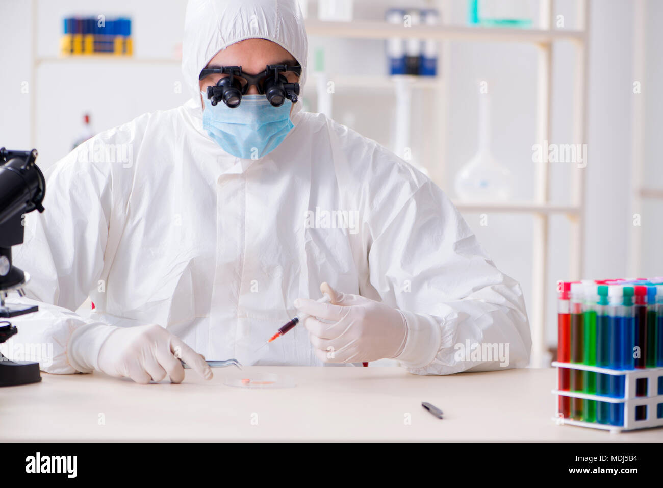 Drug synthesis concept with chemist working in research lab Stock Photo ...