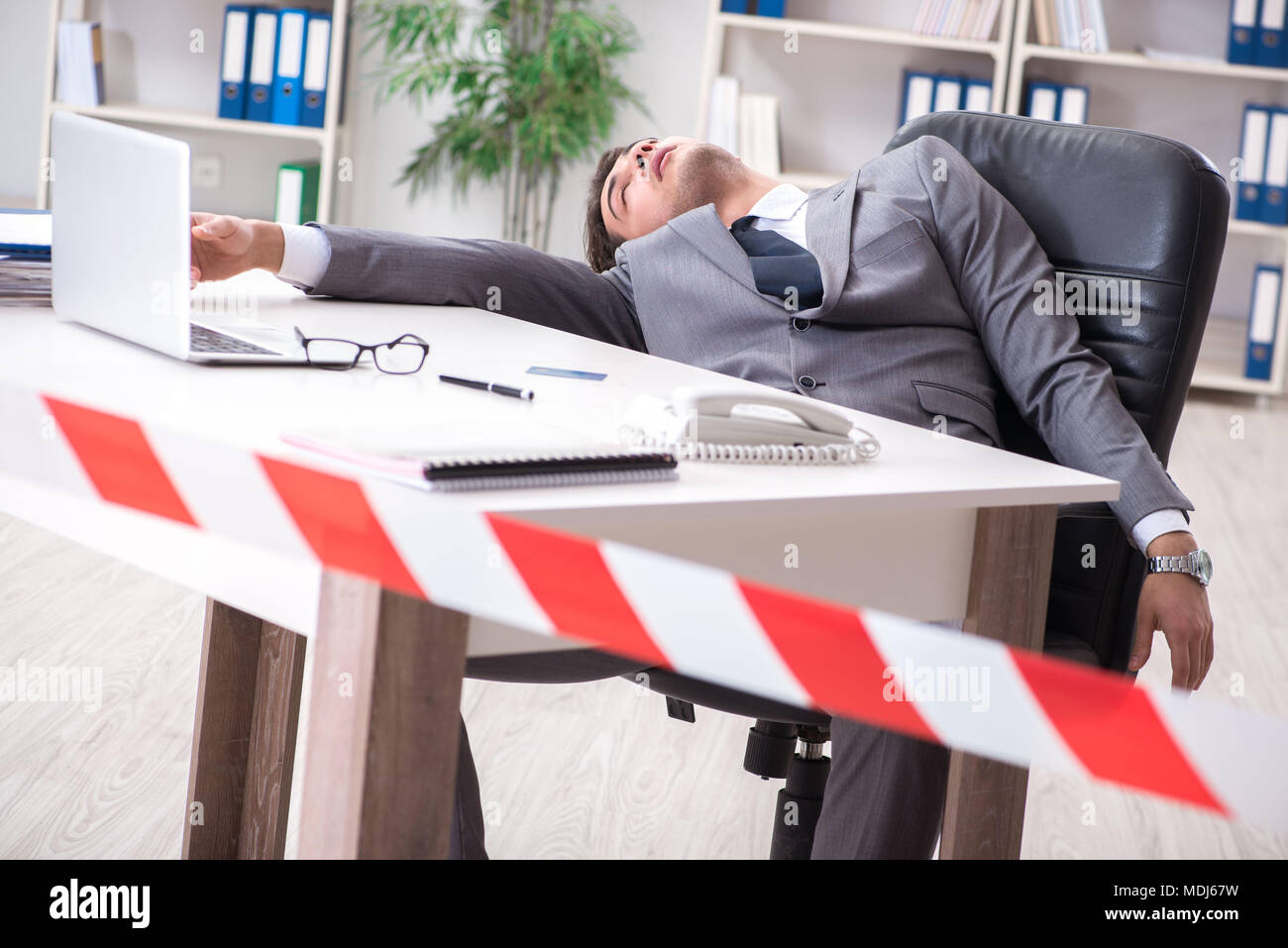 Dead businessman at this desk Stock Photo - Alamy