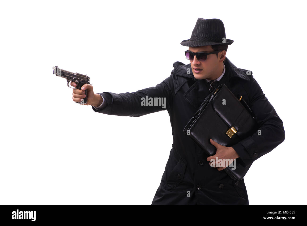 Man spy with handgun isolated on white background Stock Photo - Alamy