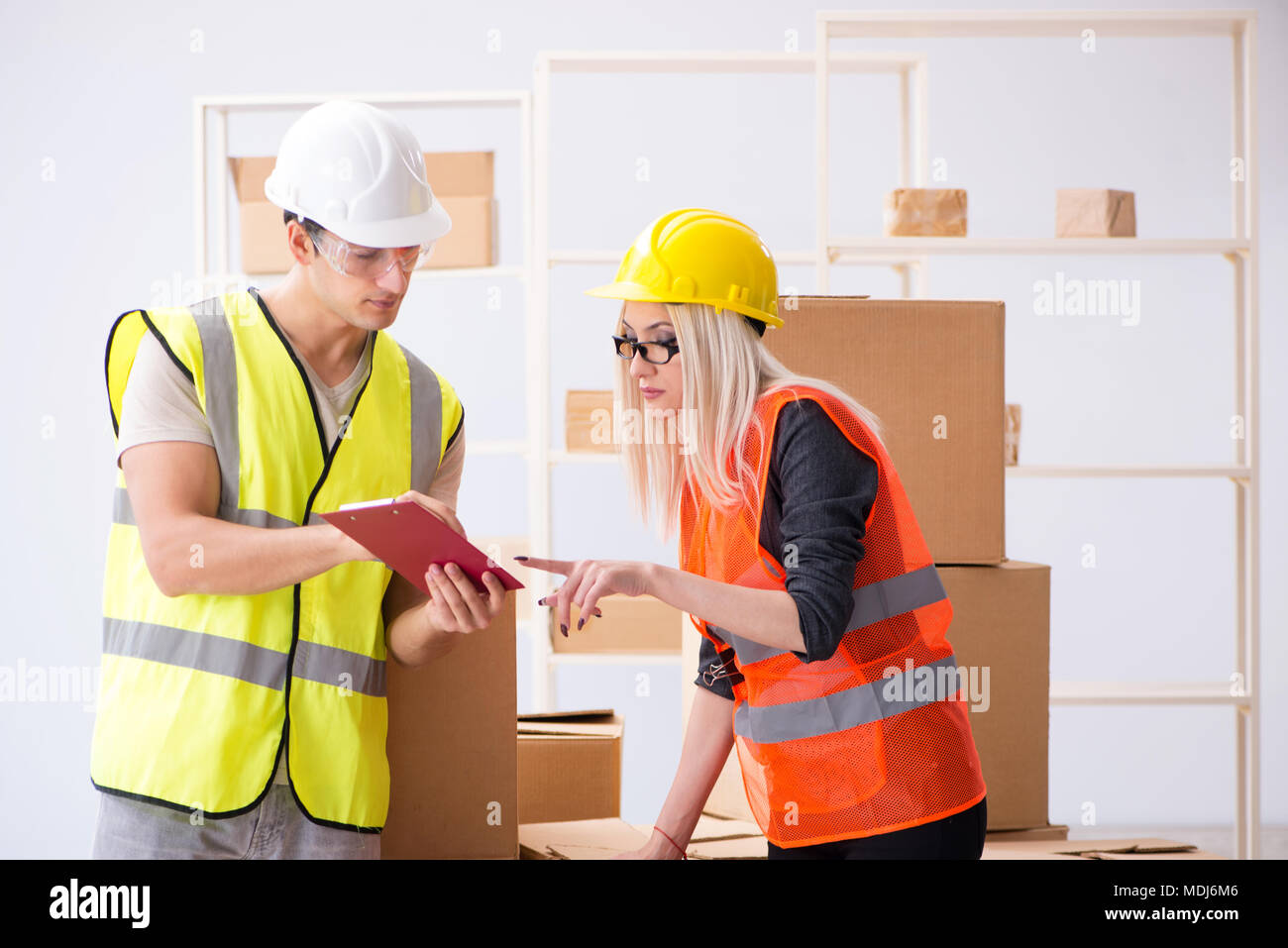 Delivery contractor delivering boxes to office Stock Photo - Alamy