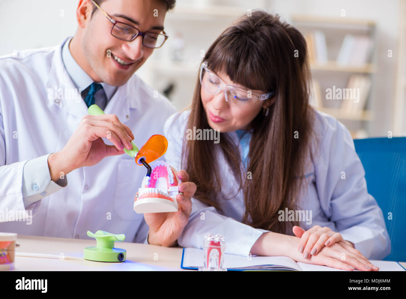 Doctor explaining to assistant how to use ultraviolet gun Stock Photo ...