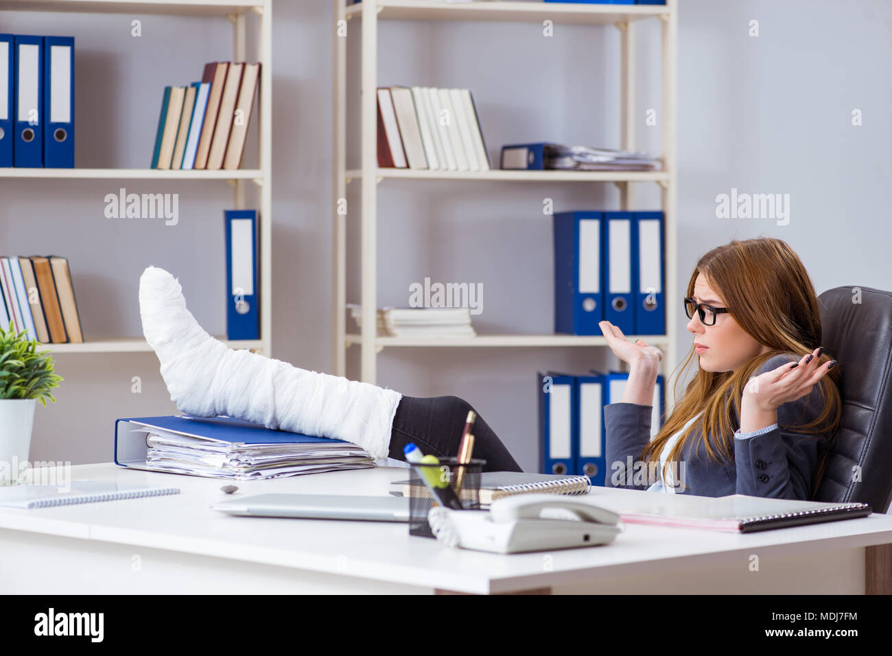 Busiesswoman employee with broken leg in office Stock Photo - Alamy