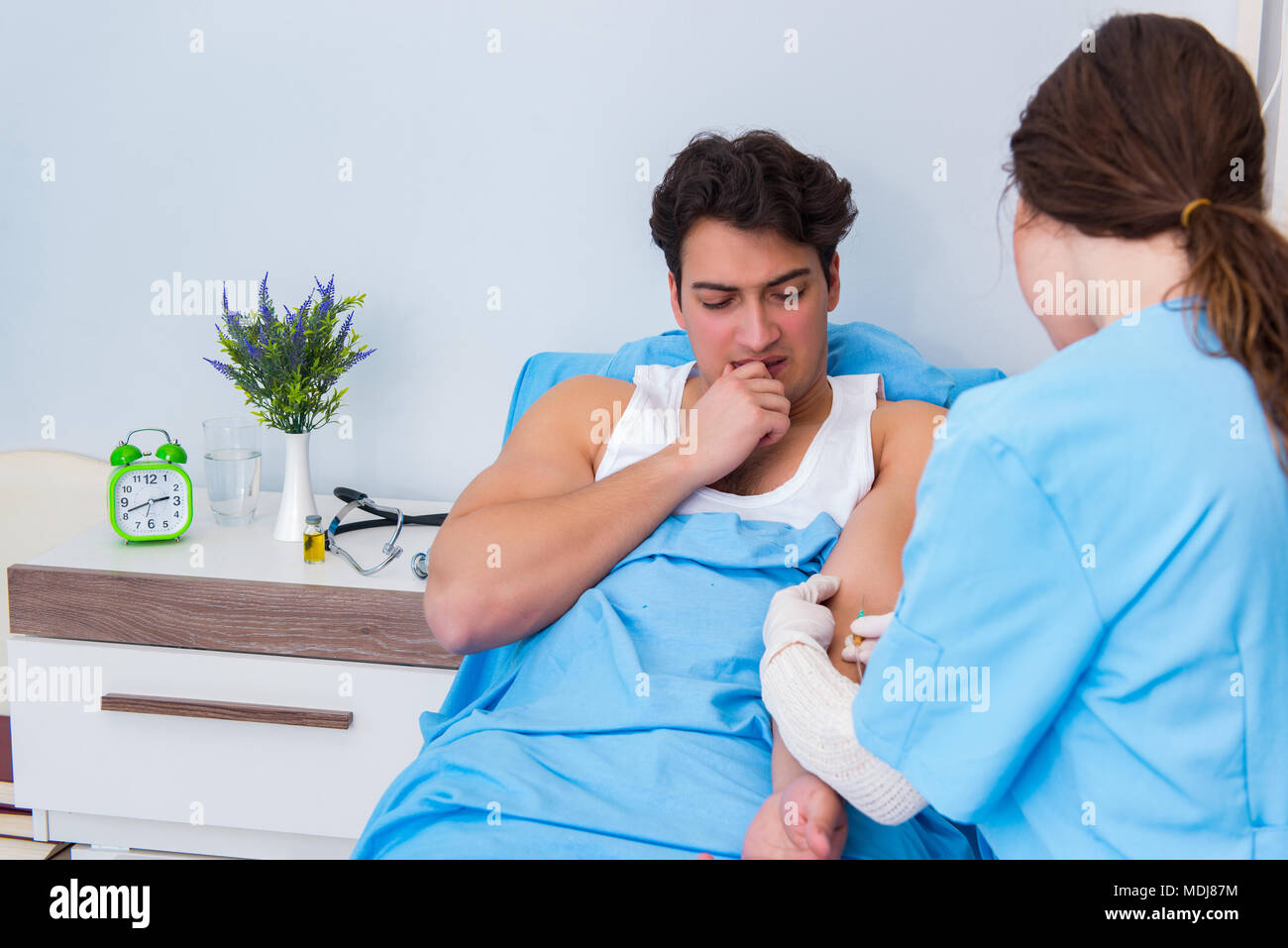 Doctor doing medical injection in hospital room Stock Photo - Alamy