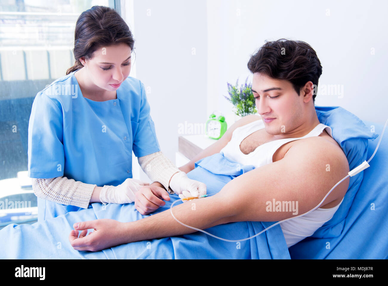 Doctor doing medical injection in hospital room Stock Photo - Alamy