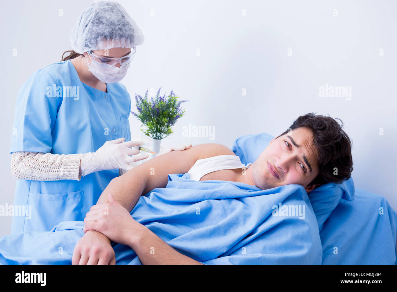 Doctor doing medical injection in hospital room Stock Photo - Alamy