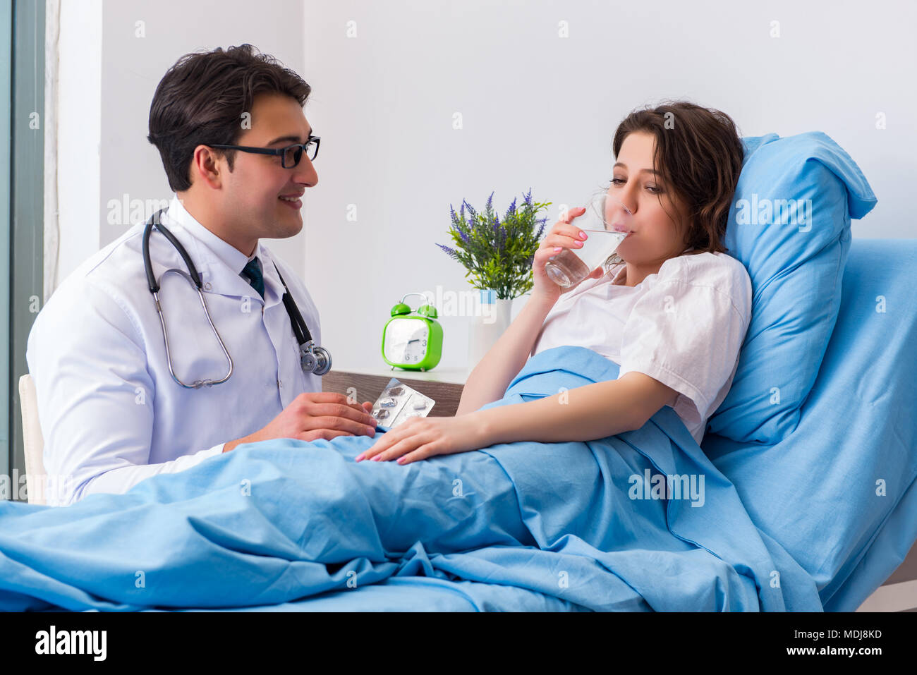 Doctor visiting patient in hospital room Stock Photo - Alamy